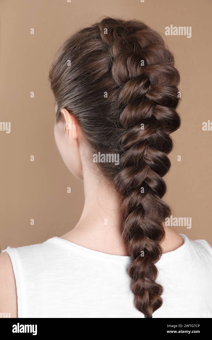 Woman with braided hair on light brown background, back view Stock ...