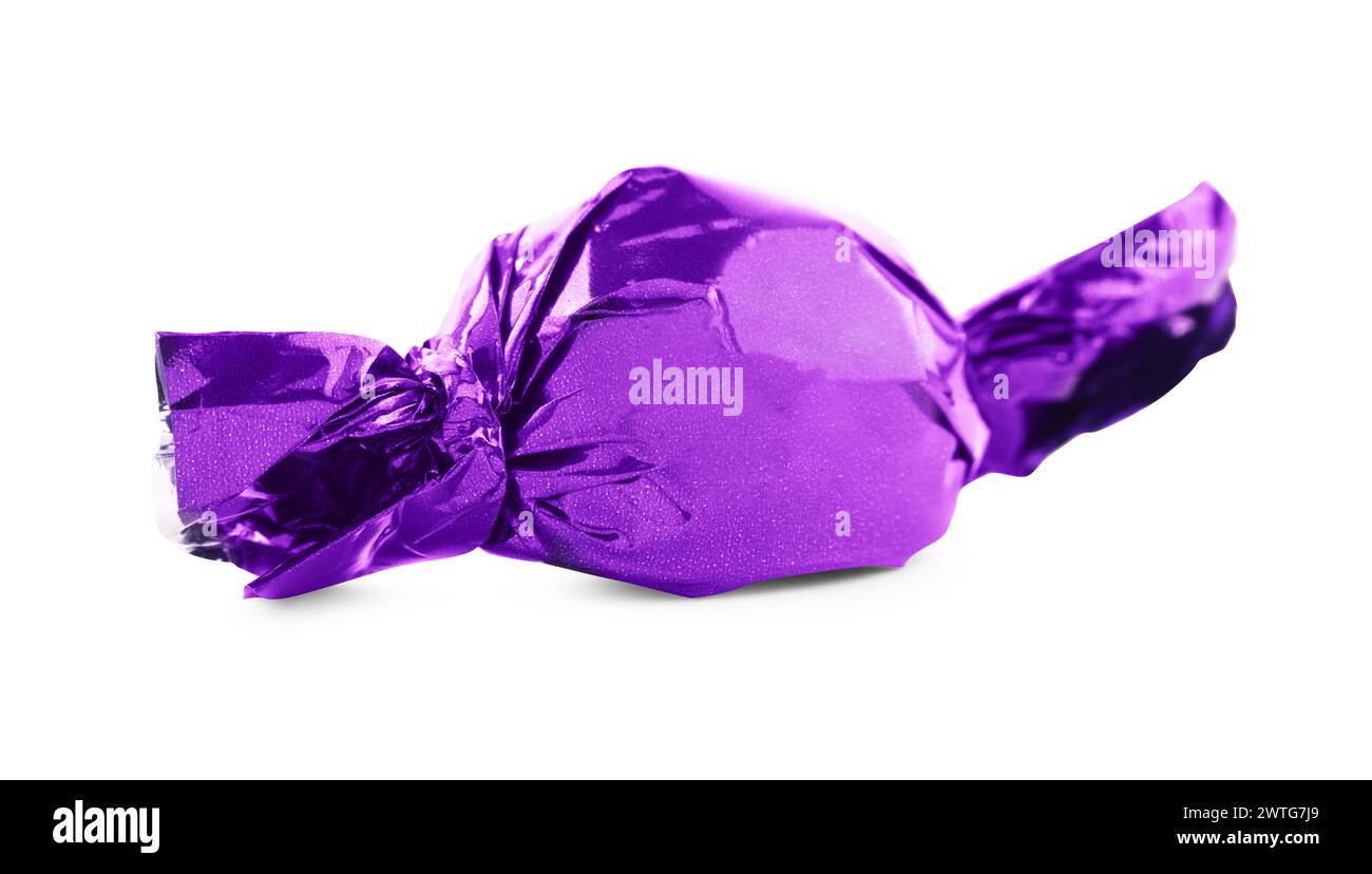 Candy in purple wrapper isolated on white Stock Photo - Alamy