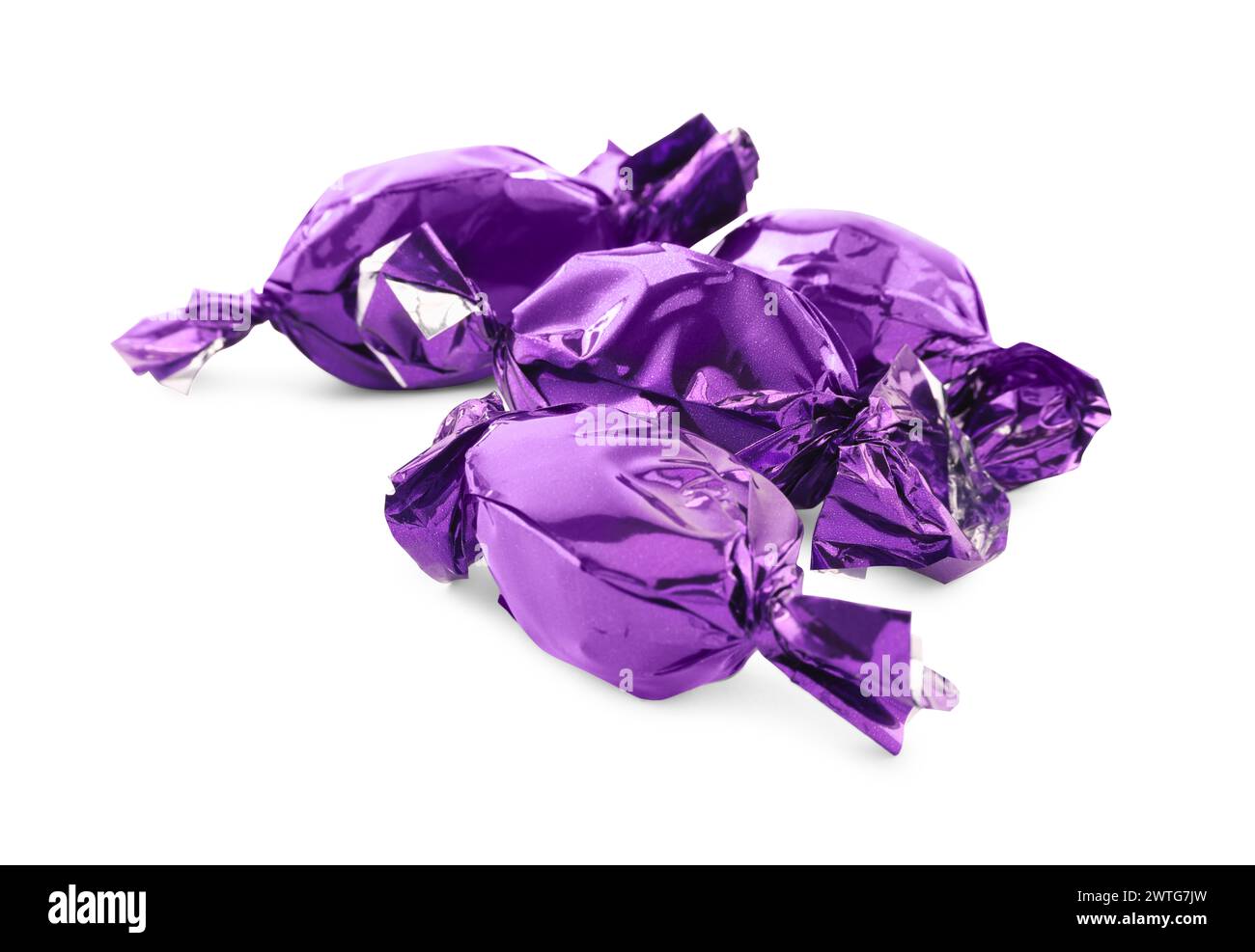 Candies in purple wrappers isolated on white Stock Photo - Alamy