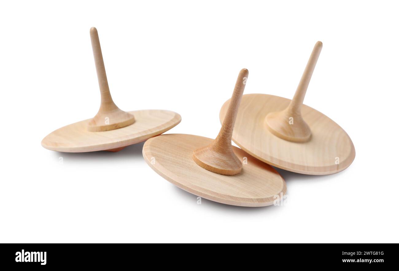 Many wooden spinning tops isolated on white Stock Photo - Alamy