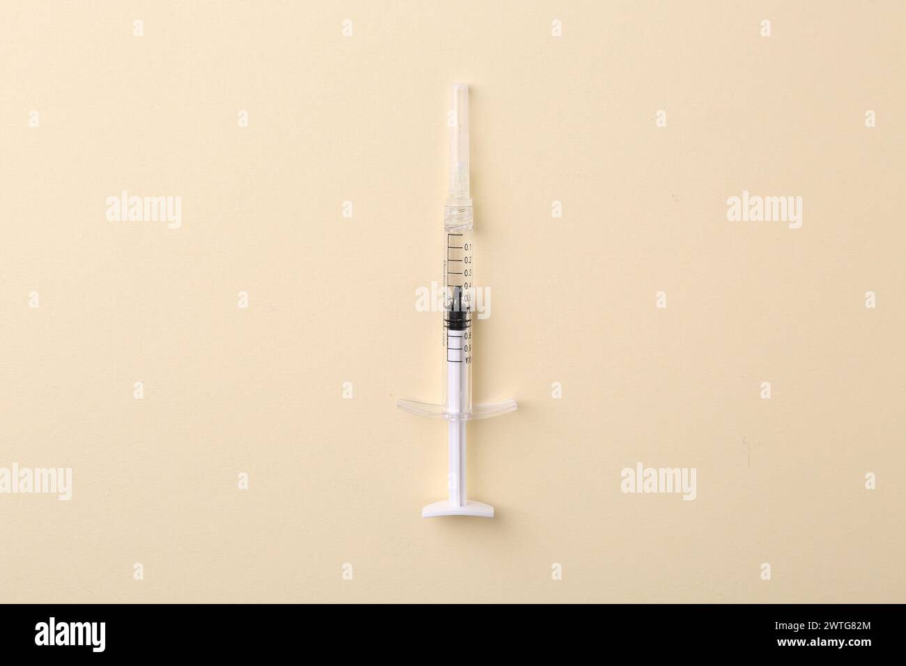 Injection cosmetology. One medical syringe on beige background, top ...