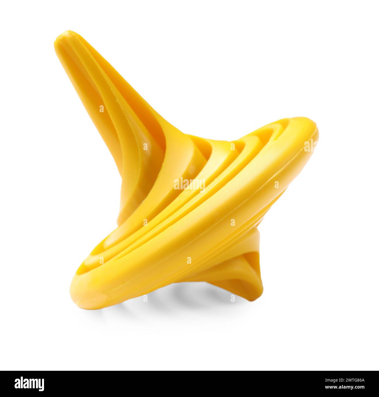 One yellow spinning top on white background Stock Photo - Alamy