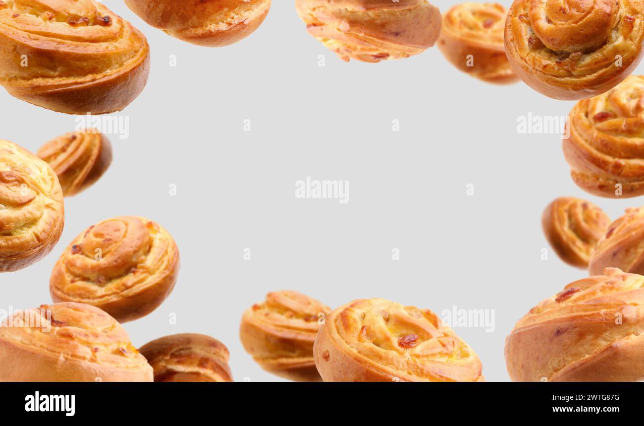 Sweet buns. Delicious rolls with raisins falling on light grey ...