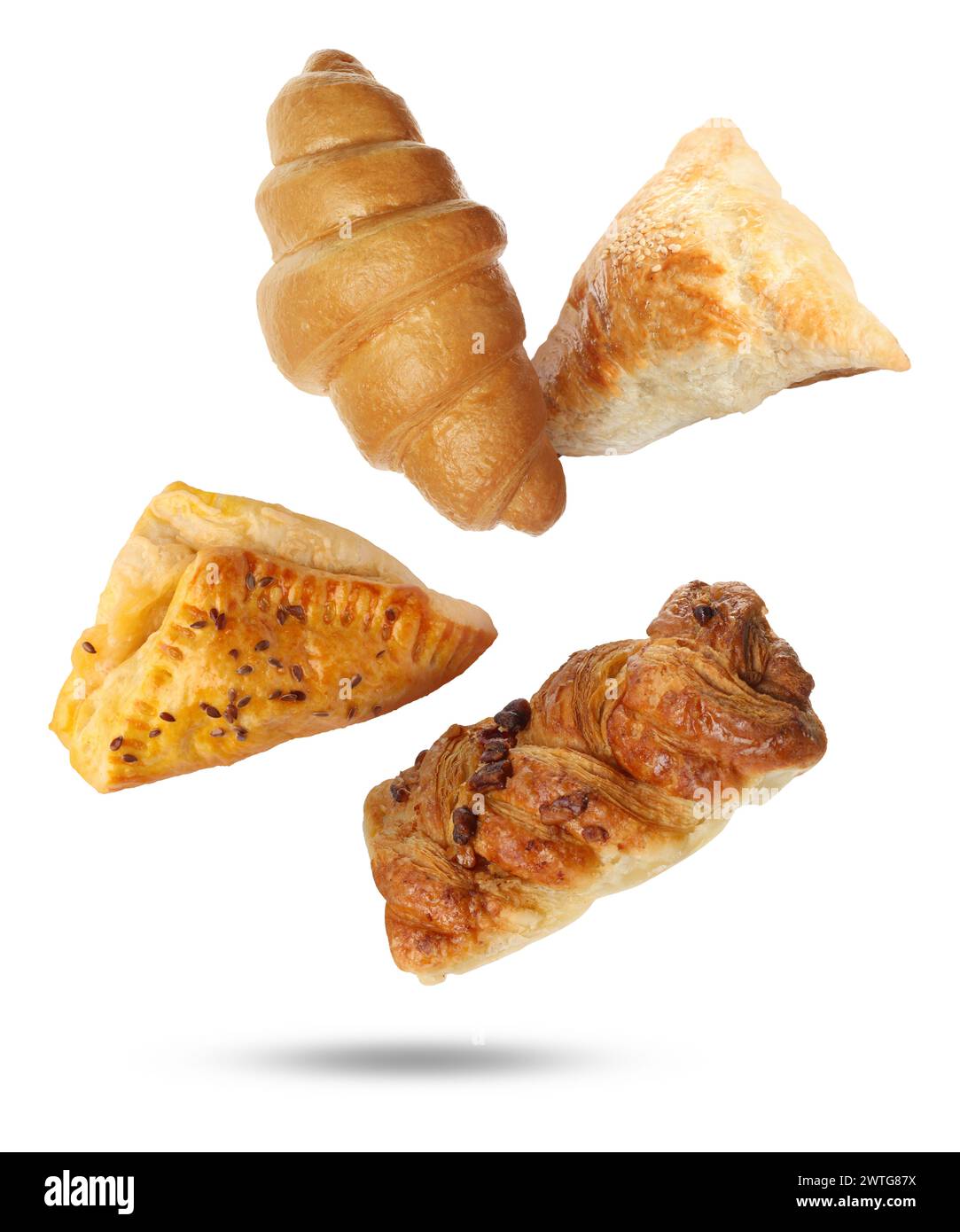 Different tasty puff pastries falling on white background Stock Photo ...