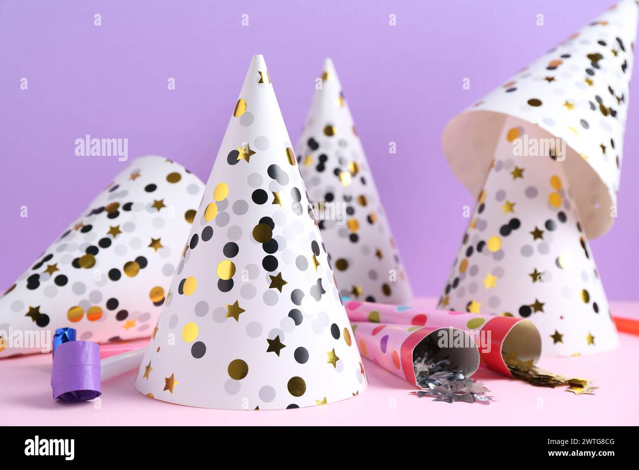 Party hats, confetti and blowers on color background Stock Photo - Alamy