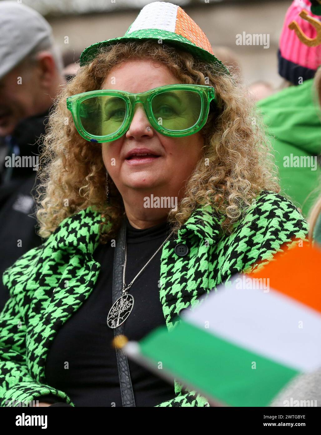 London, UK. 18th Mar, 2024. A woman attends the St. Patrick's Day ...