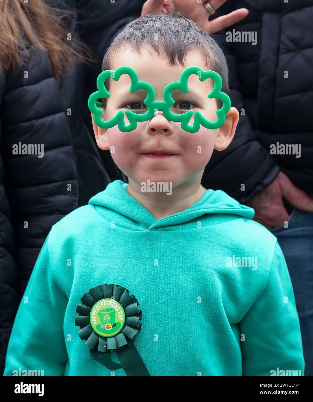 London, UK. 18th Mar, 2024. A boy attends the St. Patrick's Day Parade ...