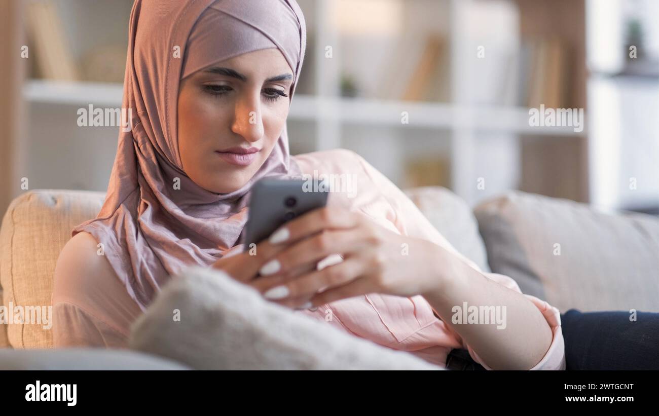 Spam message internet bullying woman phone home Stock Photo - Alamy