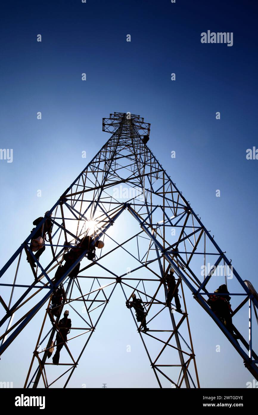The workers of the pylon Stock Photo - Alamy