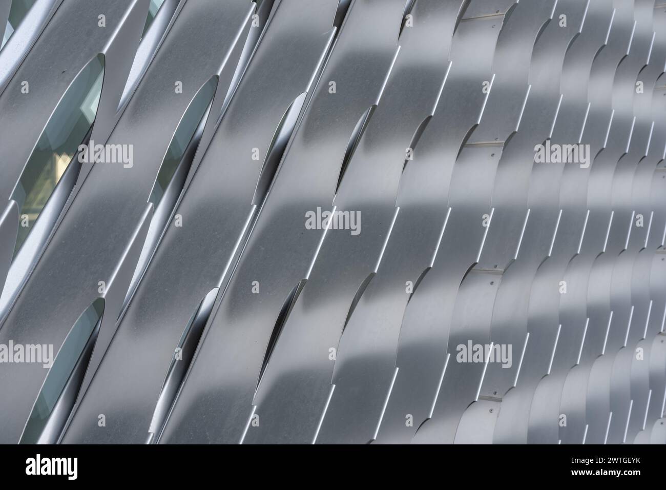 Close-up photo of silver gray angled exterior aluminum louvers over a ...