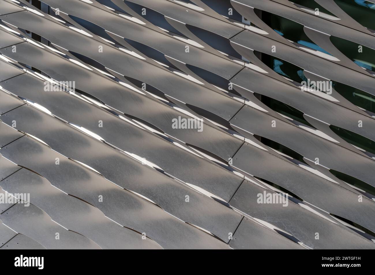 Close-up photo of silver gray angled exterior aluminum louvers over a ...