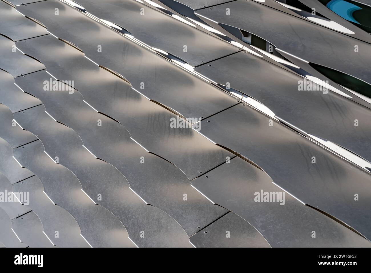 Close-up photo of silver gray angled exterior aluminum louvers over a ...