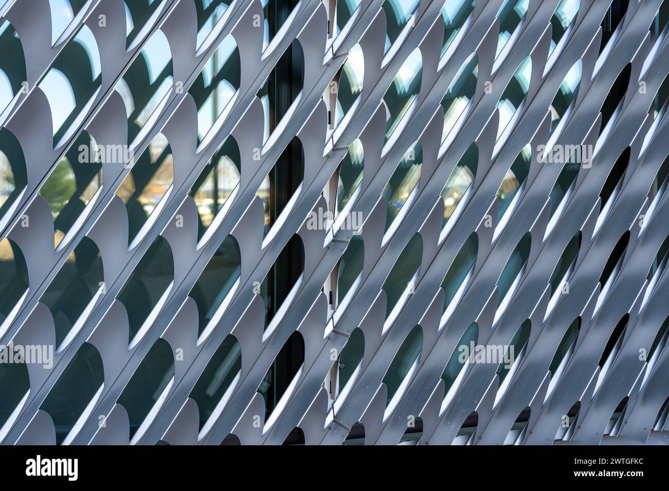 Close-up photo of silver gray angled exterior aluminum louvers over a ...