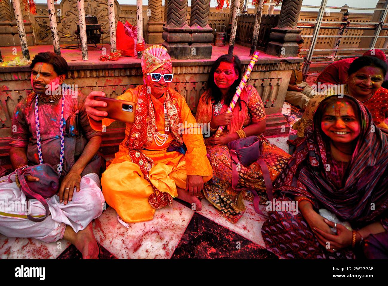 A Hindu priest seen taking selfies with his family members during the ...