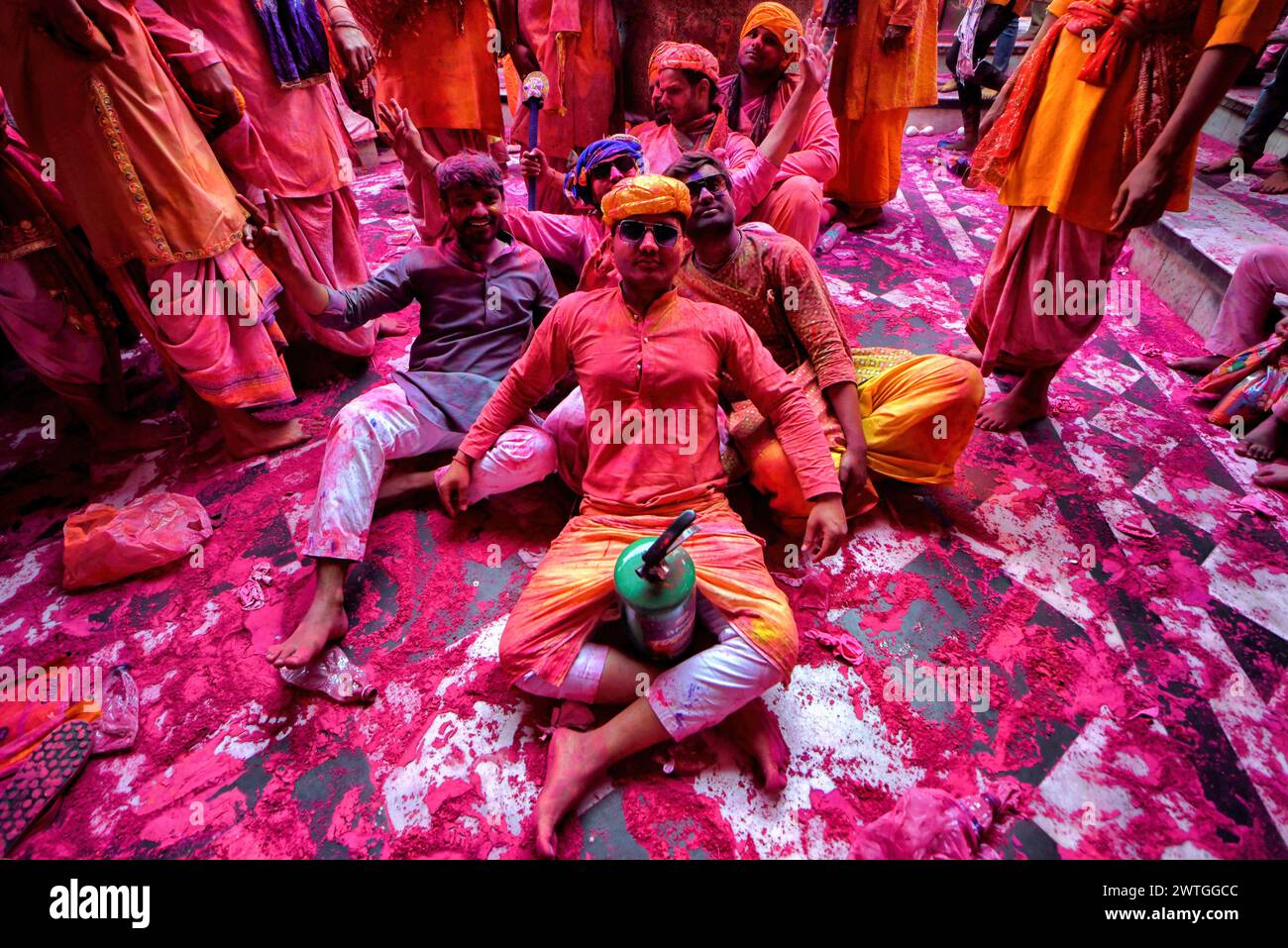 Mathura, India. 17th Mar, 2024. Devotees seen posing for a photo as they celebrate Laddu Holi ...