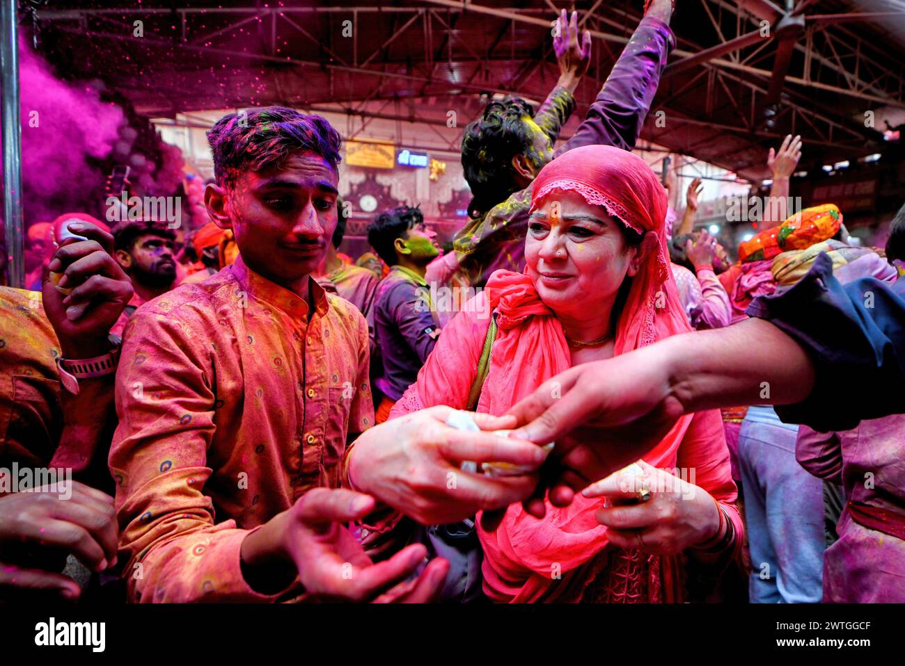 Mathura, India. 17th Mar, 2024. Hindu devotees seen distributing Laddu ...