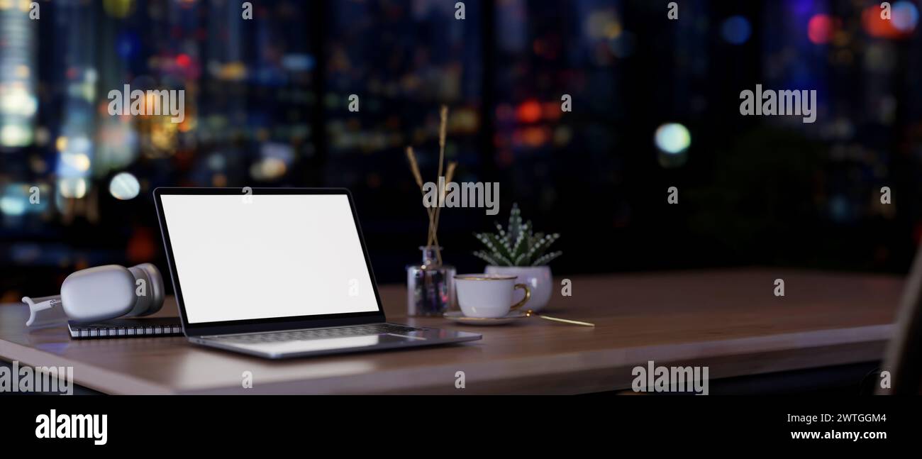 A white-screen laptop computer mockup on a desk in a contemporary ...