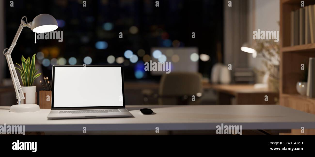 An office desk features a white-screen laptop computer mockup and ...