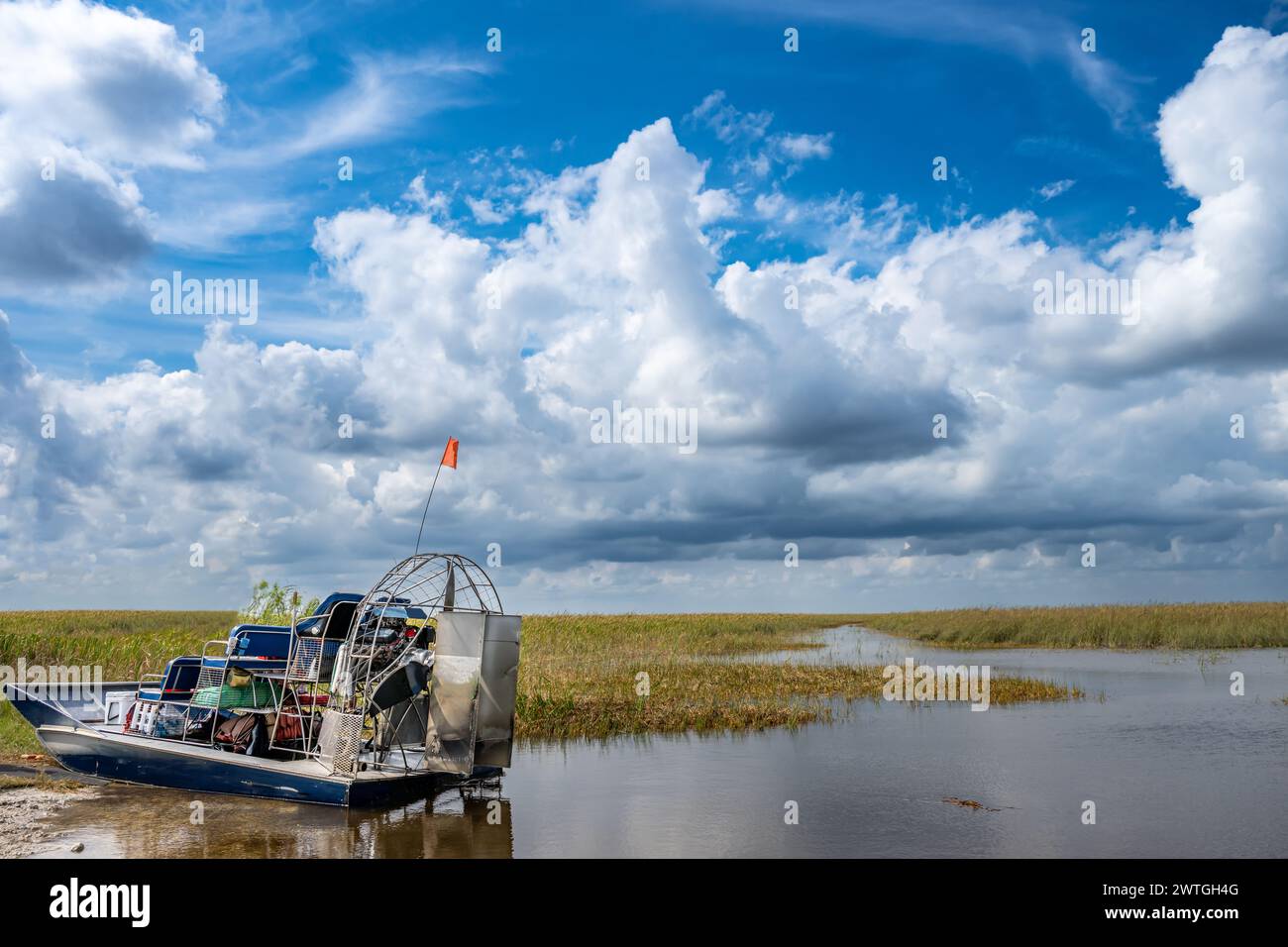 Docked airboat in the everglades of Florida with grass and wetland ...