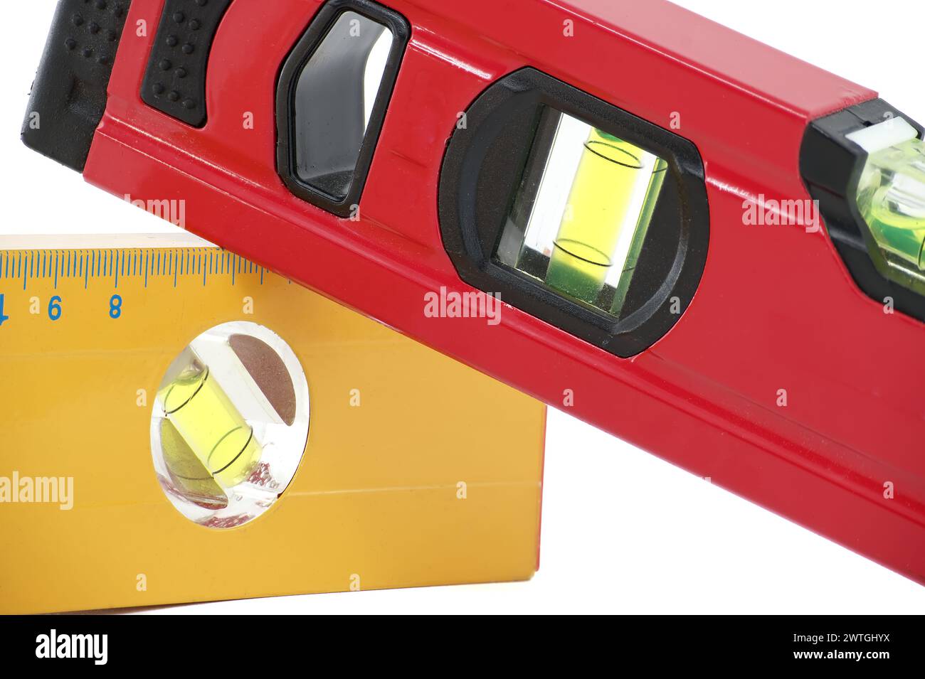 Red and yellow spirit level with a bubble indicator displayed against a ...