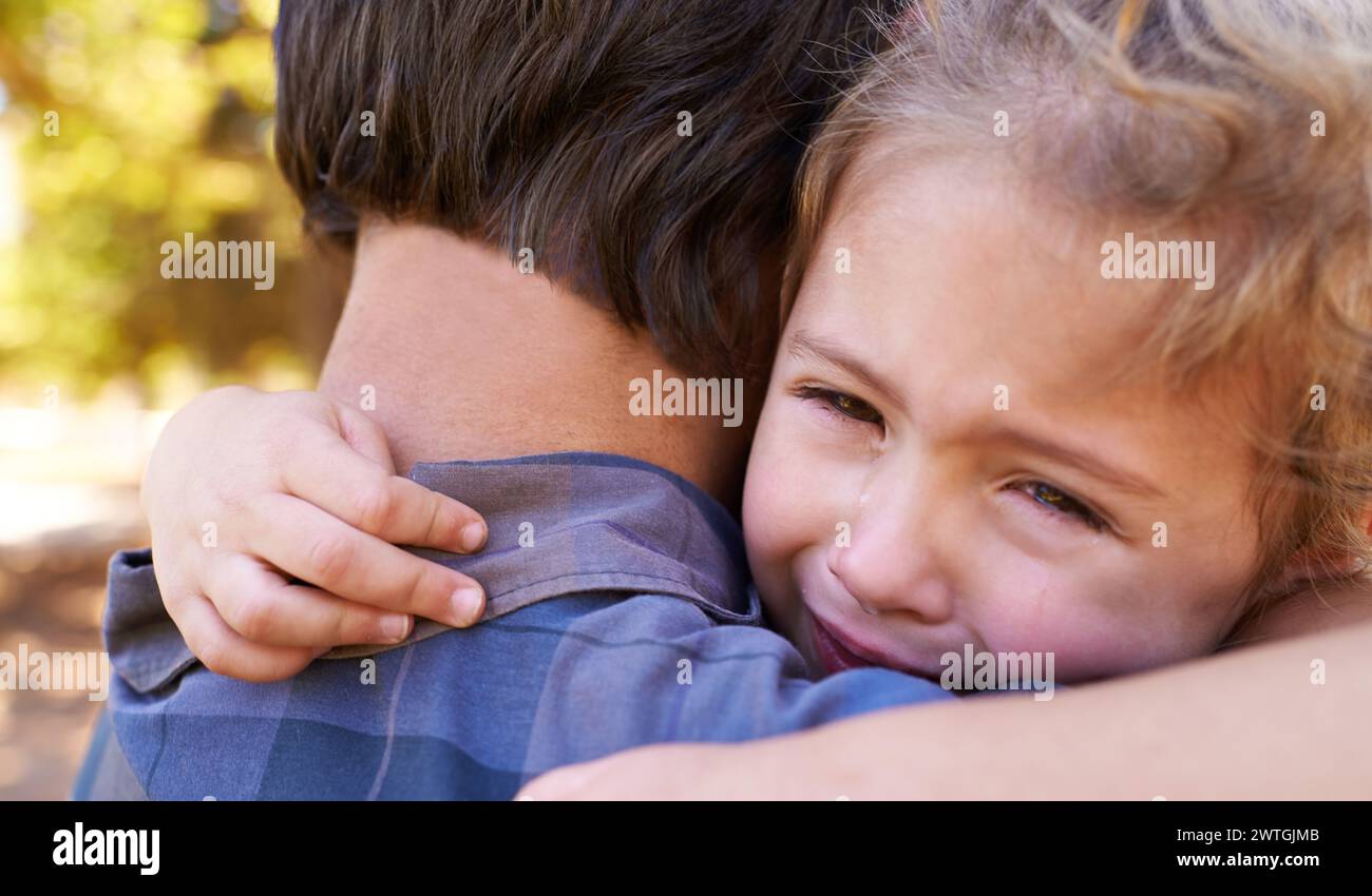 Hug, sad girl and father in a park, emotions and expression with ...