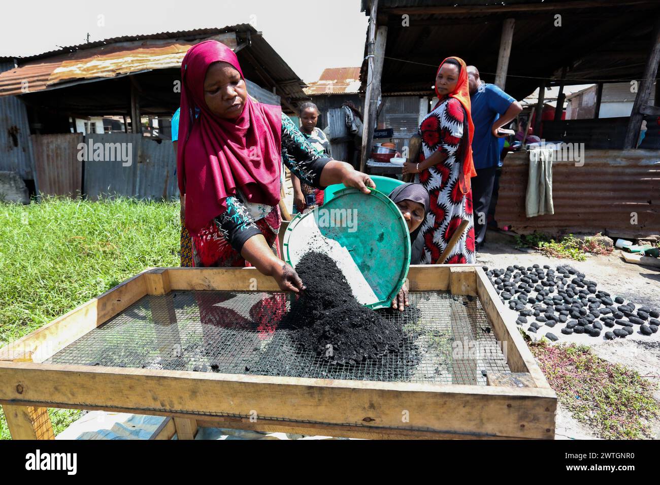 Dar Es Salaam, Tanzania. 16th Mar, 2024. Members of a women's group use ...