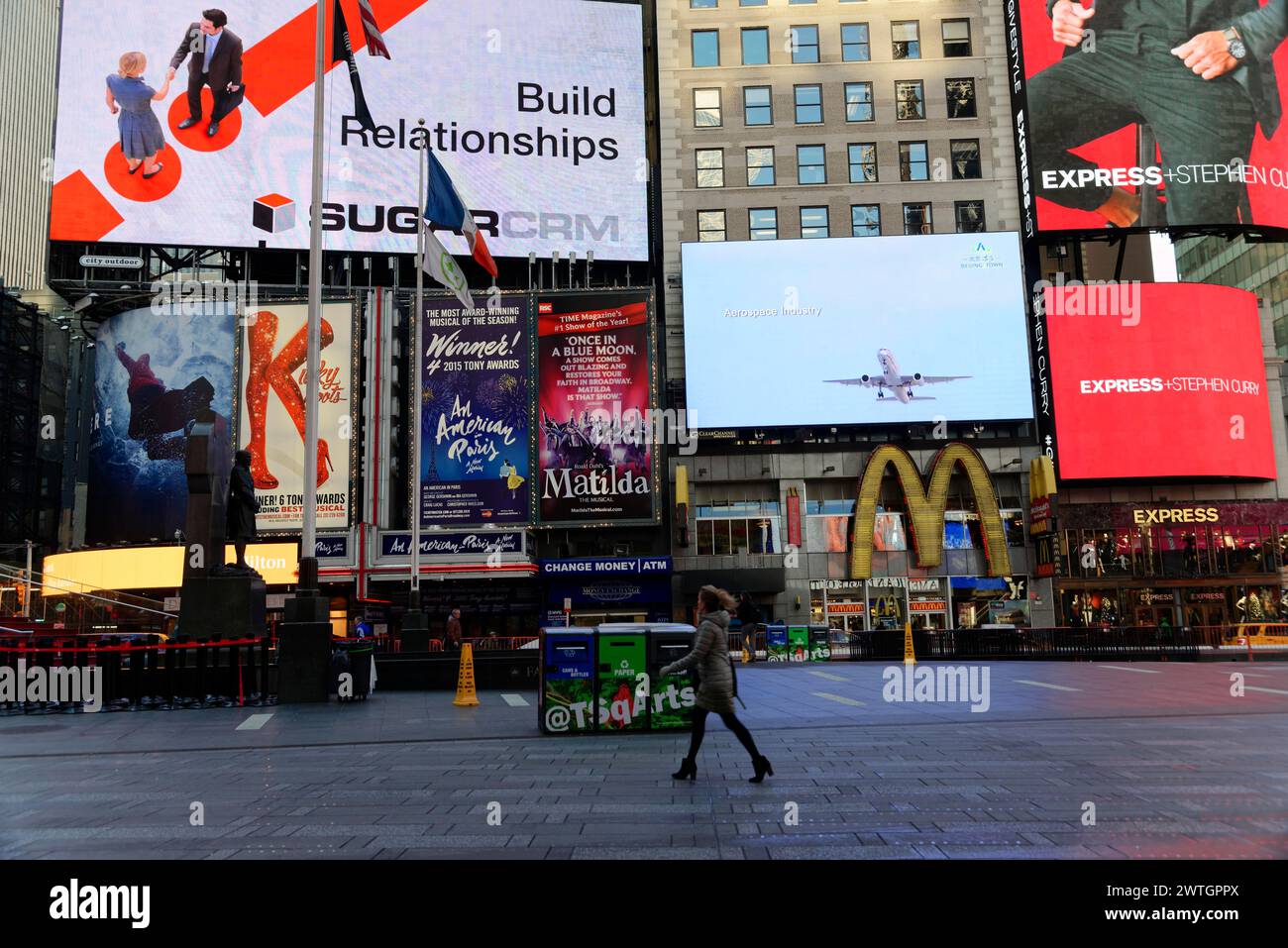 Times Square in the morning with lively billboards and few passers-by ...