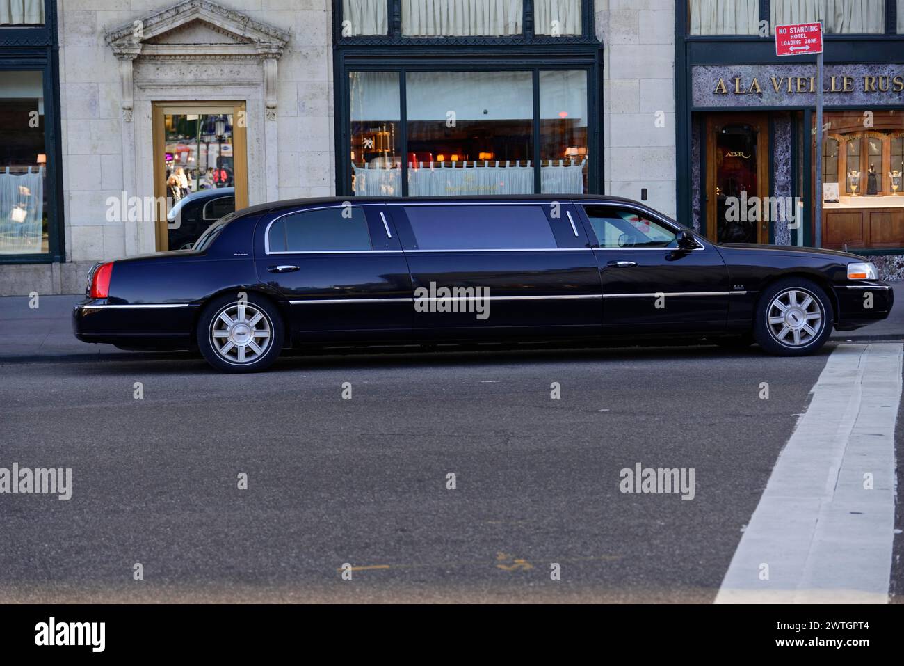 A black limousine parked on the roadside in an urban environment ...