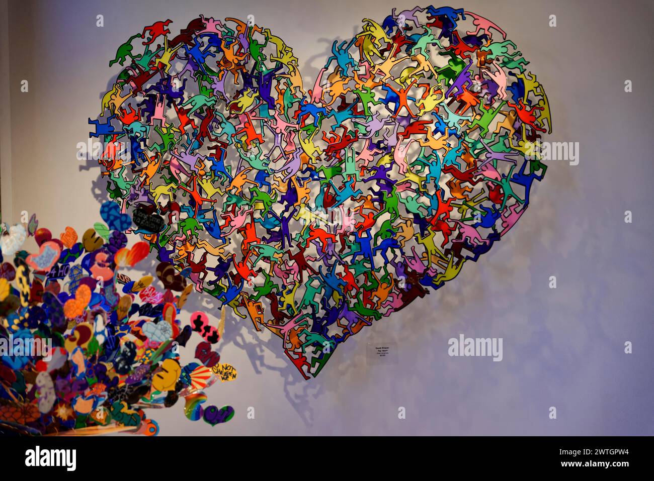 Colourful heart made of puzzle pieces on the wall in artistic style ...