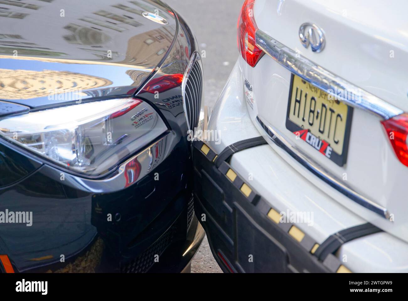 Two parked cars standing very close to each other in an urban ...
