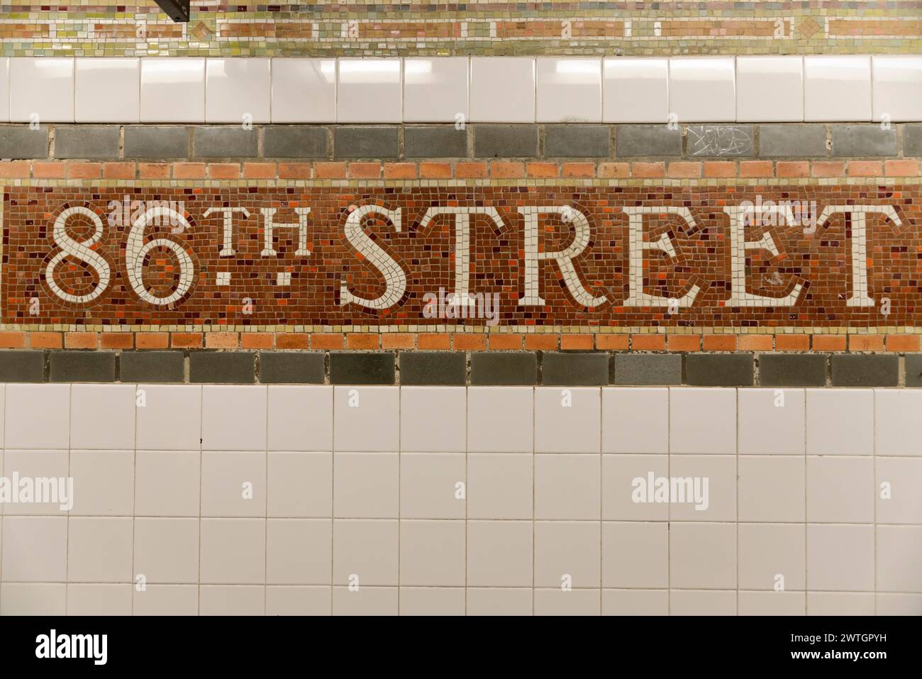 Mosaic sign '86th Street' on the wall of an underground station ...