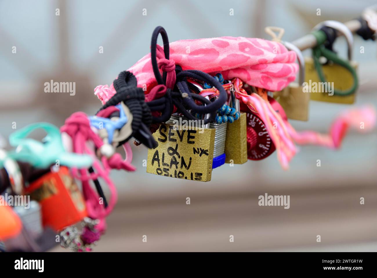 Brooklyn Bridge, close-up of a golden love lock wrapped with a pink ...