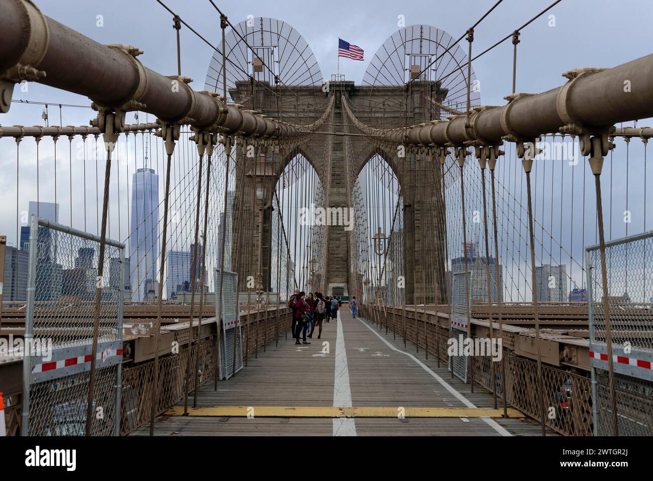 Strollers on the Brooklyn Bridge with detailed view of the cable ...