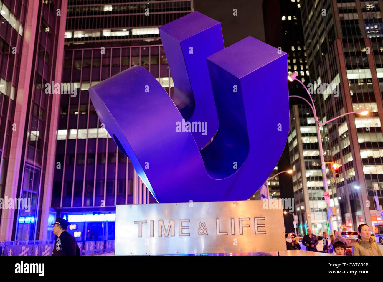 A purple modern sculpture in front of the Time & Life building with ...