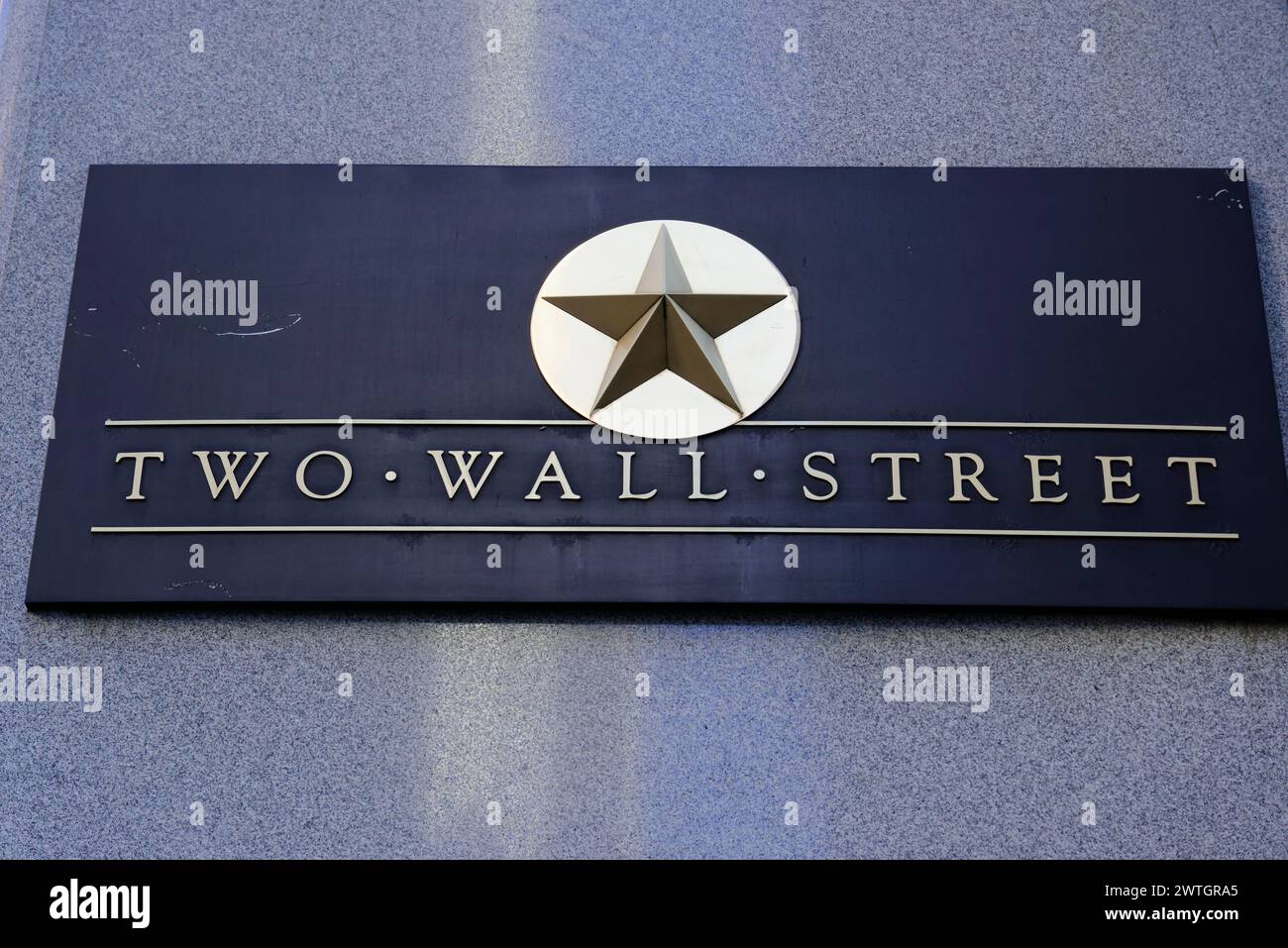 Black company sign with the address Two Wall Street and a star symbol ...