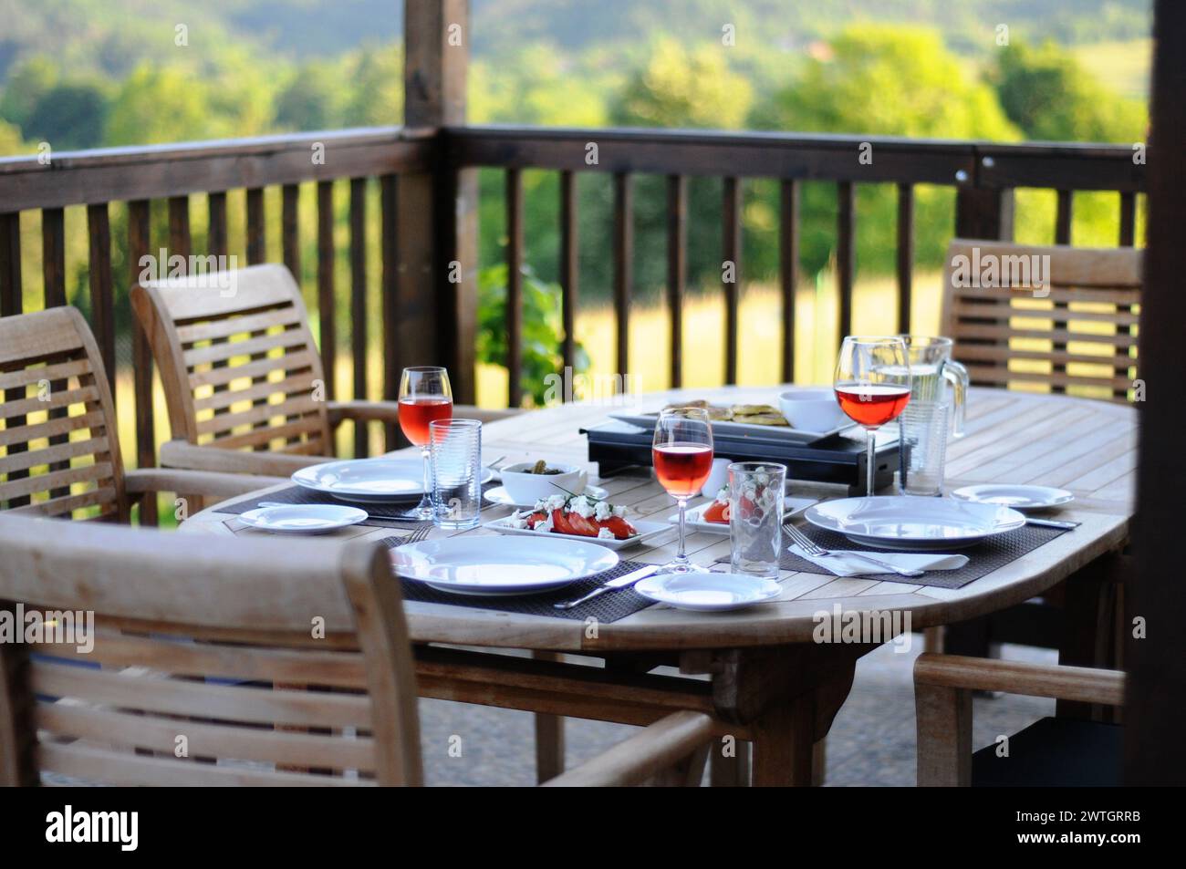 Outdoor dinner balcony green surroundings Stock Photo - Alamy