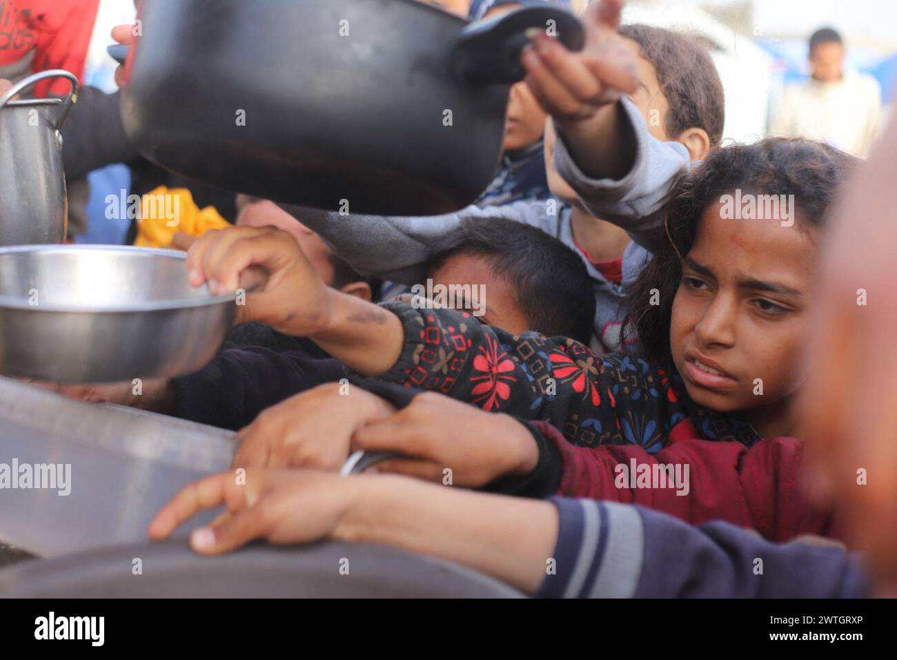 People gather to get food relief in the southern Gaza Strip city of ...
