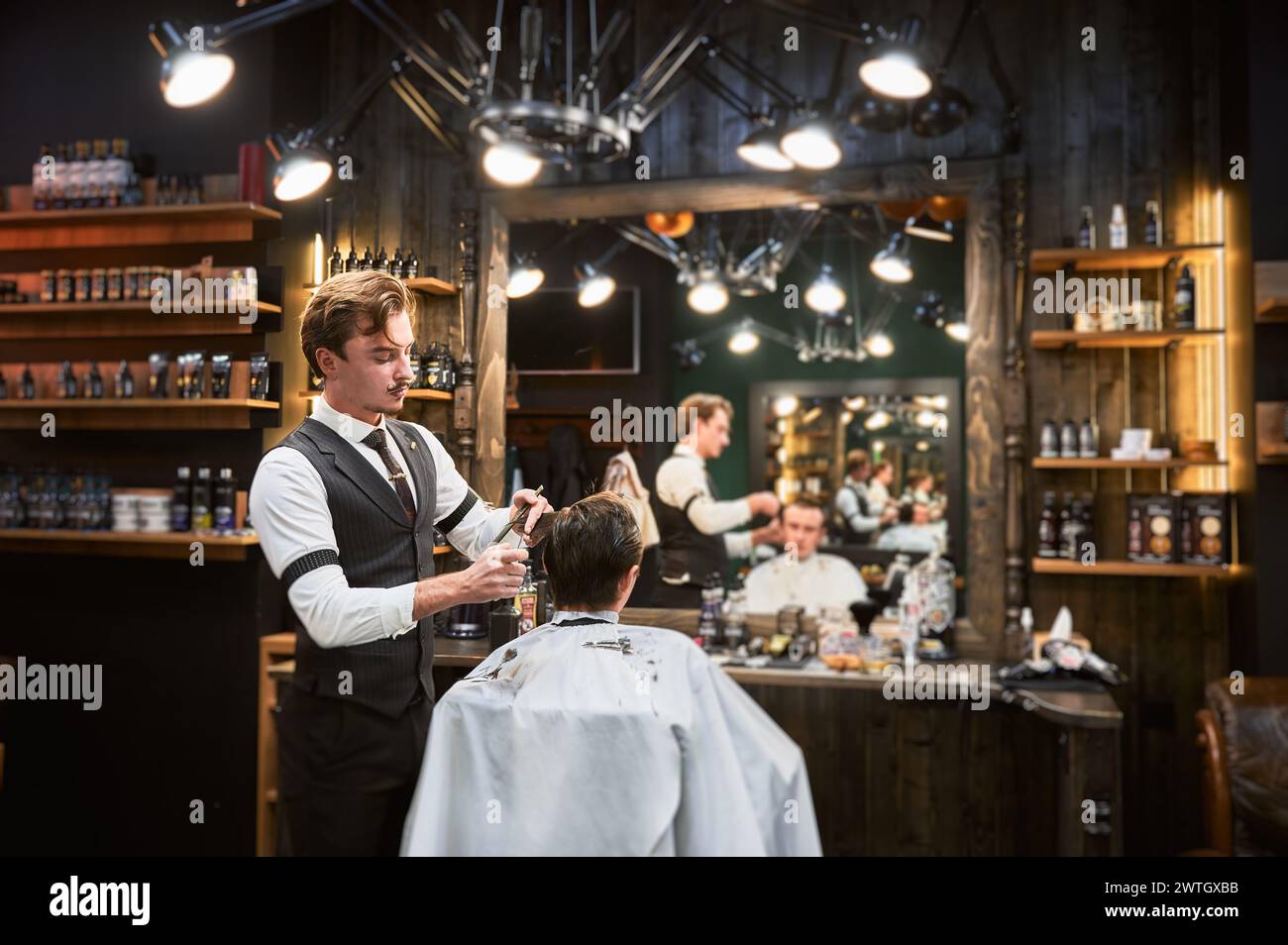 Cropped photo of handsome hairdresser in fancy outfit cutting wet hair ...