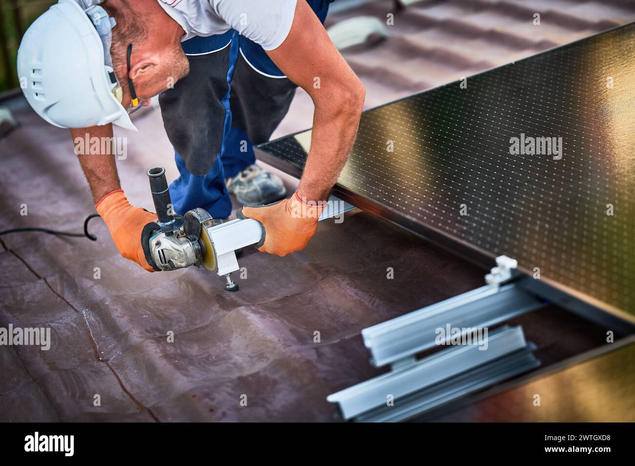 Worker installing or maintaining photovoltaic solar panel system on ...
