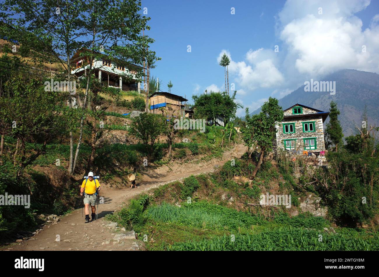 Hiker trekking in green mountains on trail between Jiri and Lukla ...