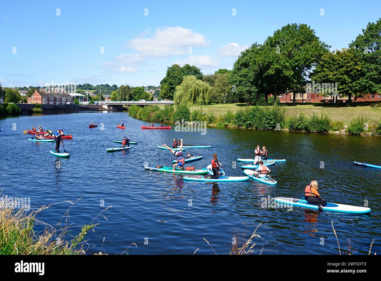 People paddleboarding and canoeing along the river Exe, Exeter, Devon ...