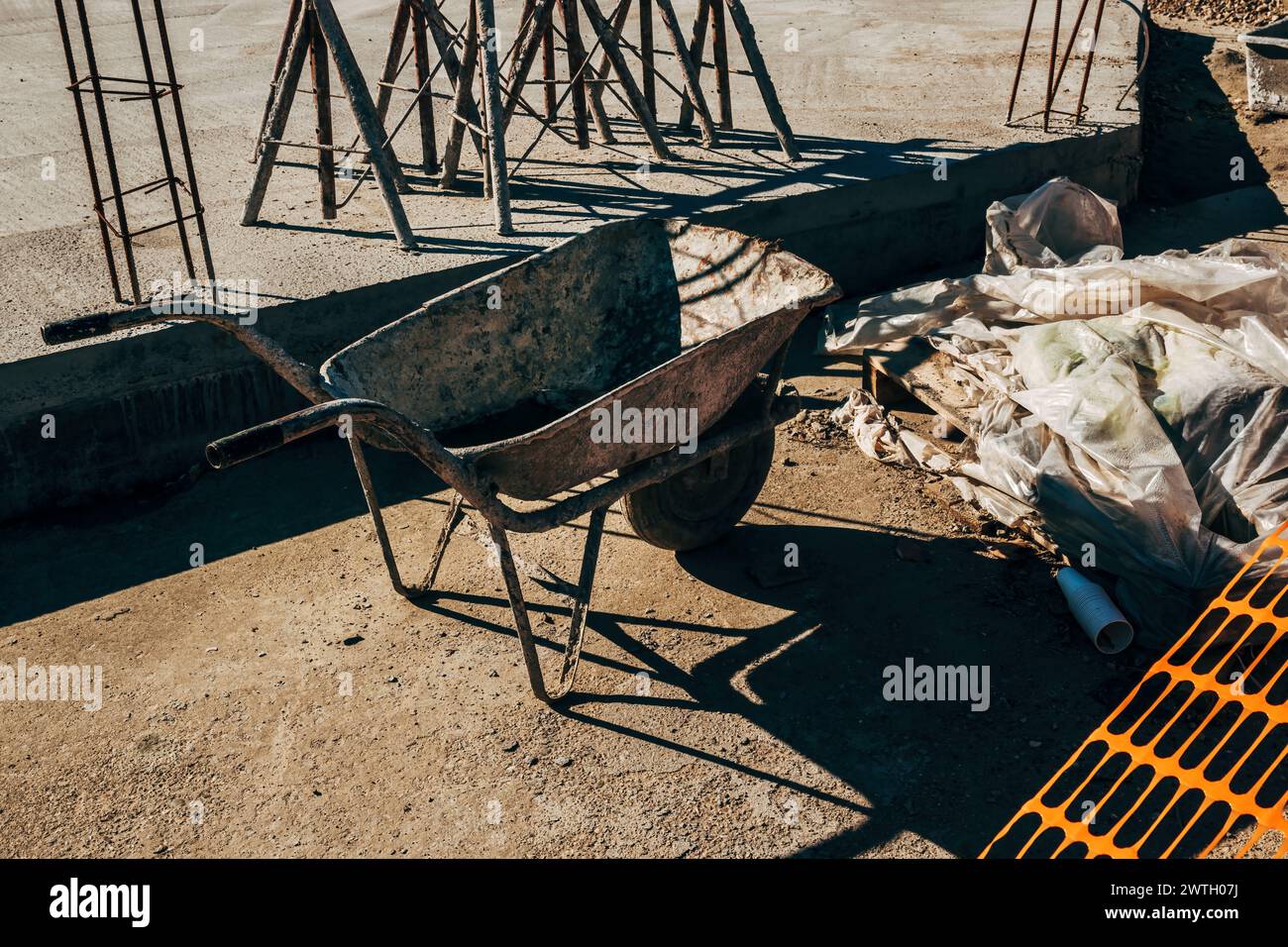 Old dirty push wheelbarrow cart on construction site, selective focus ...