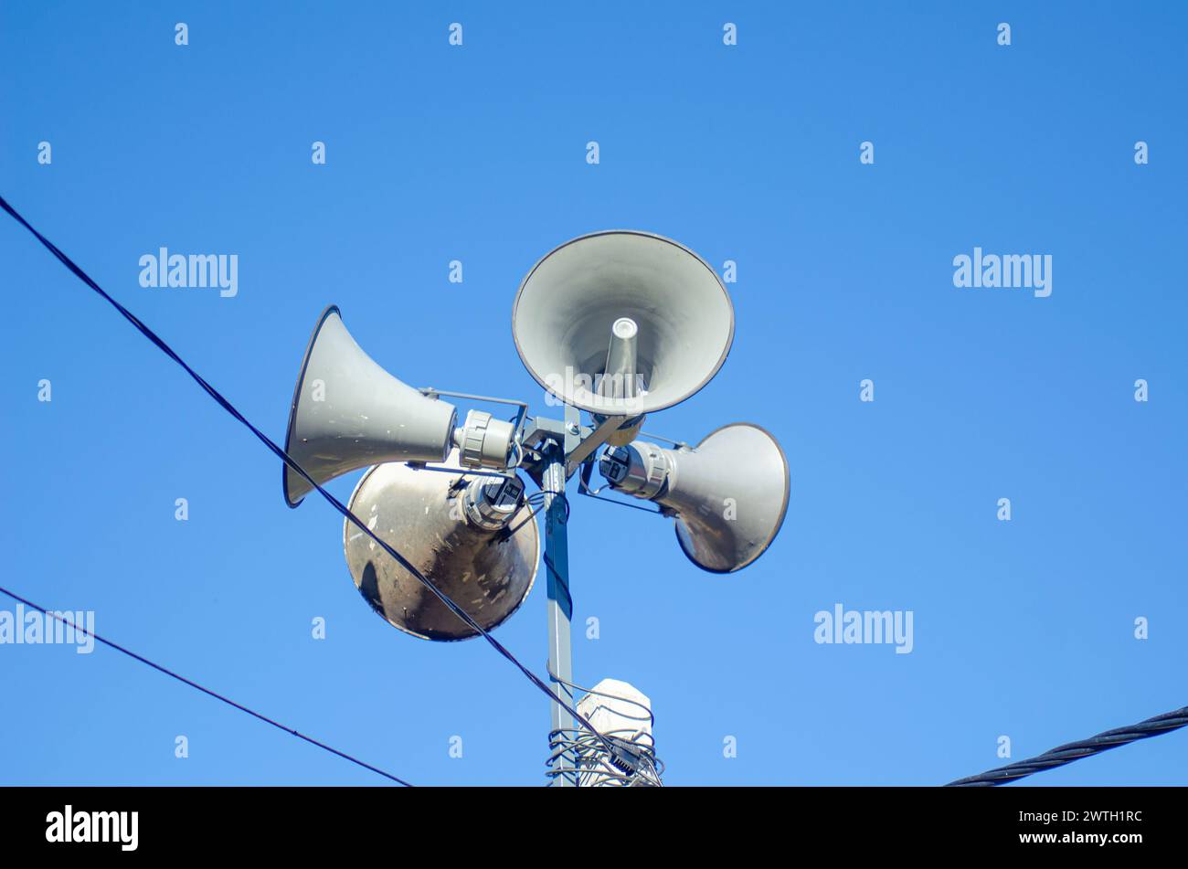 four loudspeakers on top of a pole Stock Photo - Alamy