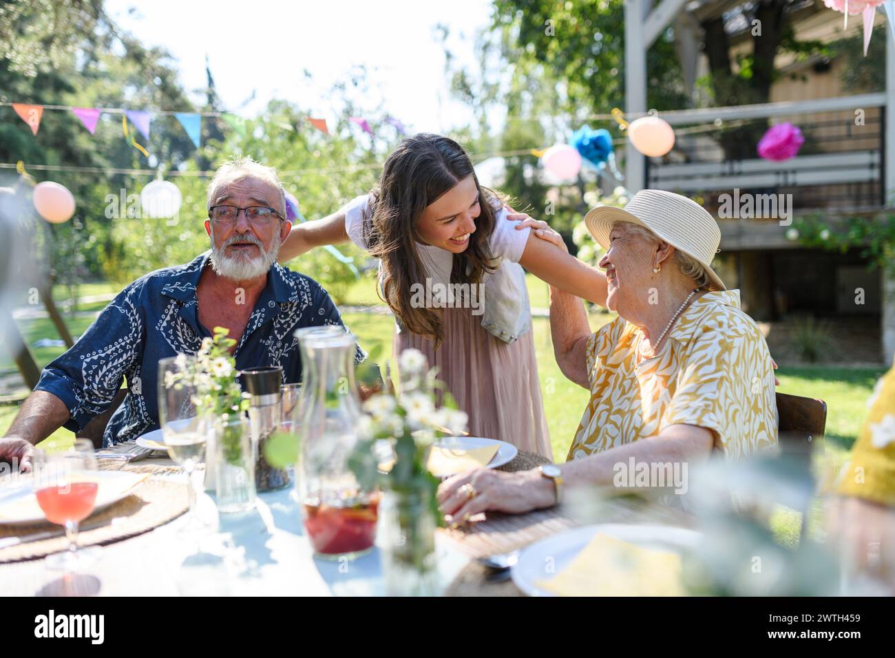 Mature granddaughter talking with grandparents, reunite after a long ...
