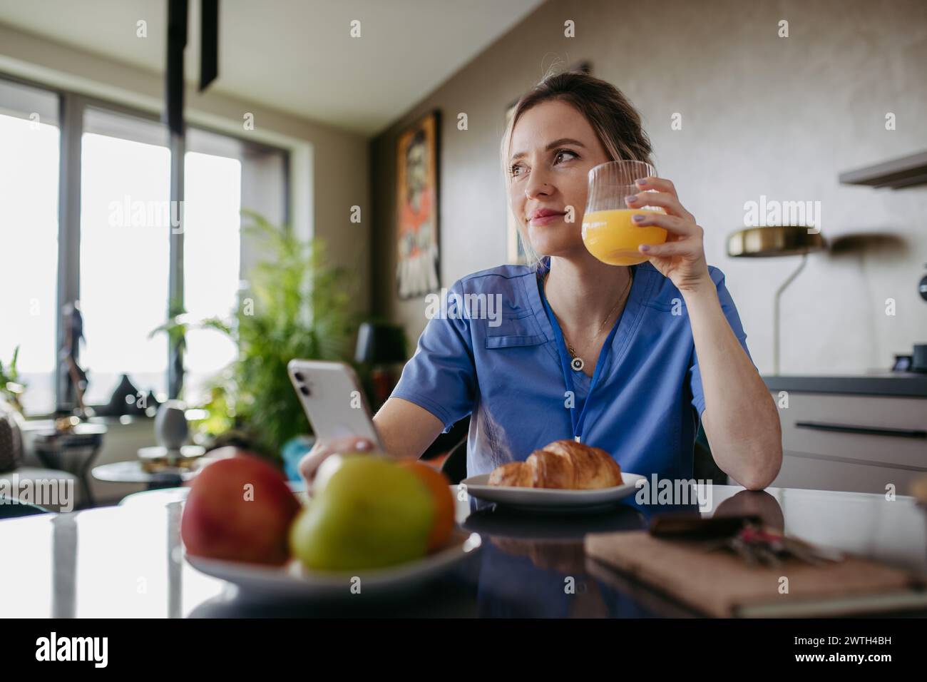 Female nurse or doctor getting ready for work in the morning, scrolling ...