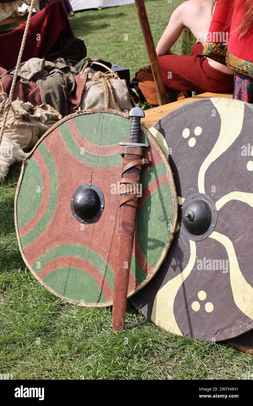 Medieval weapons, shields in knight camp at the festival of historical ...