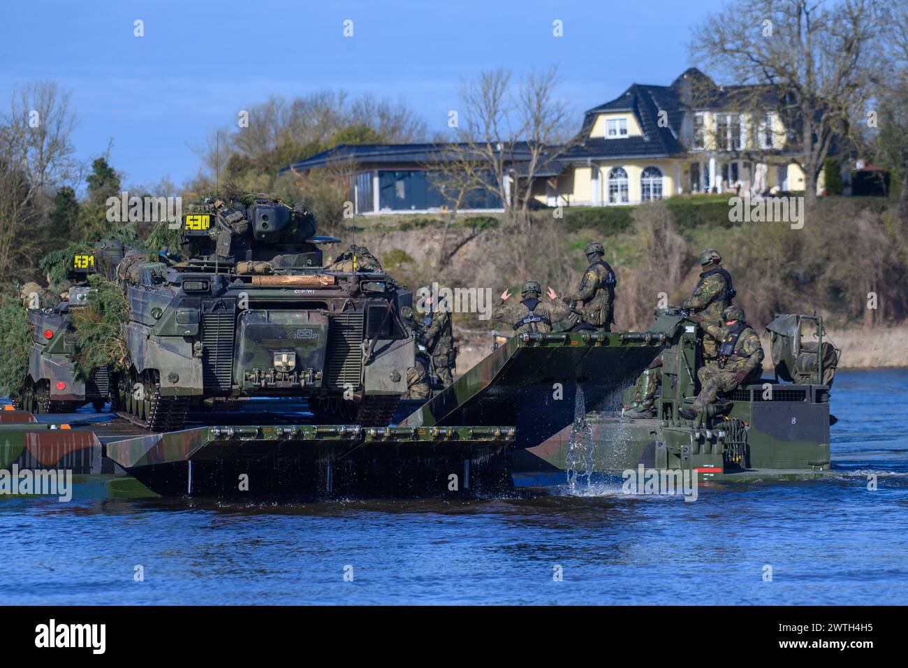 18 March 2024, Saxony-Anhalt, Hohengöhren: Bundeswehr soldiers cross ...