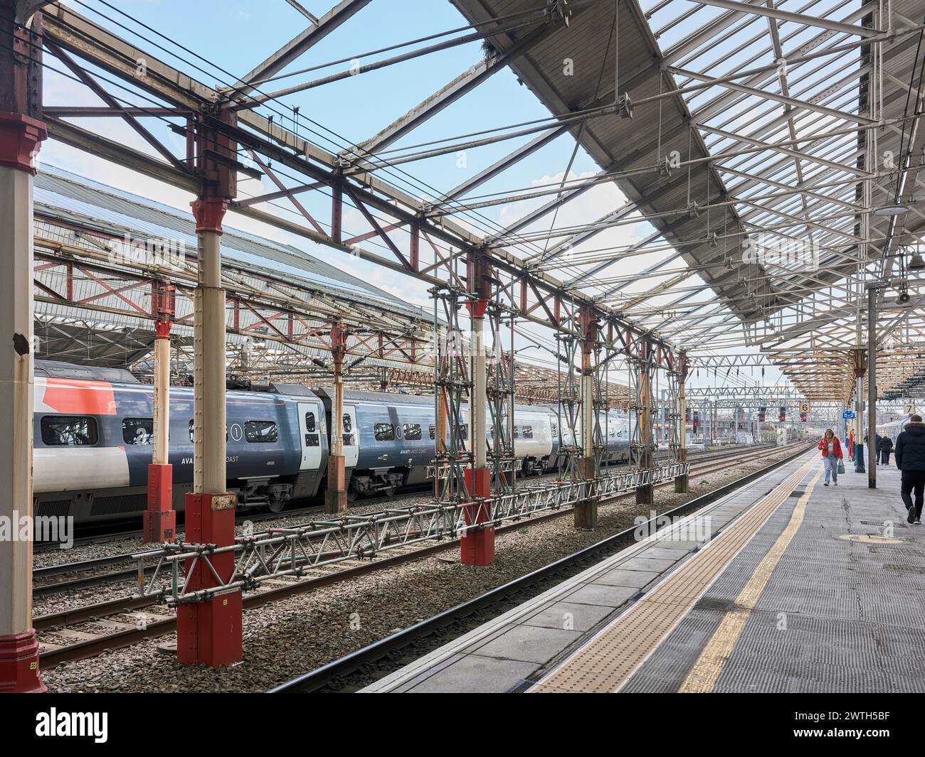 Train stationary by a platform at the railway station in Crewe, England ...
