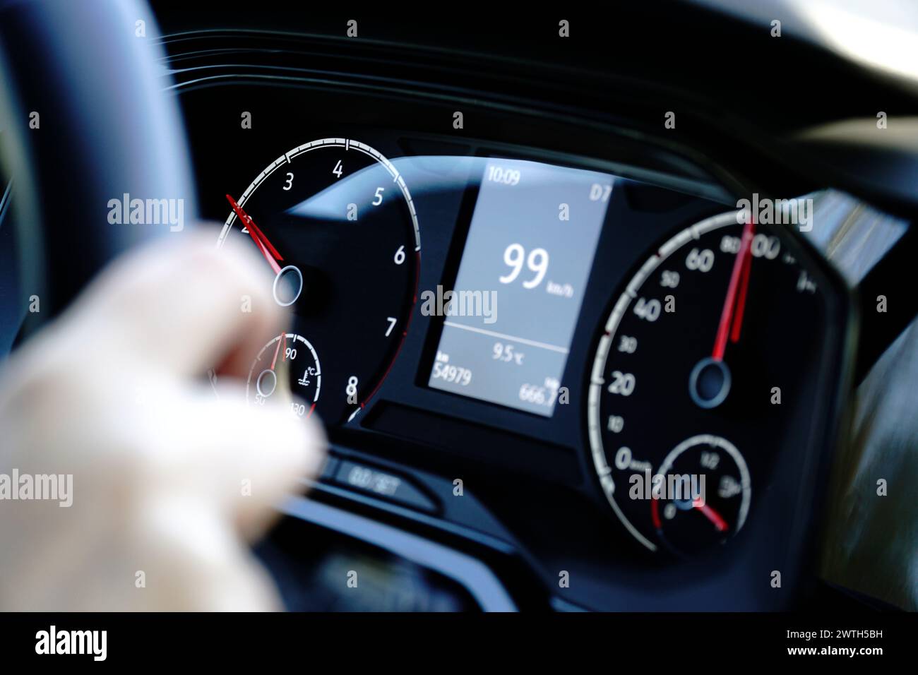 Speedometer and hands on a steering wheel - driving at 99 kmh Stock ...