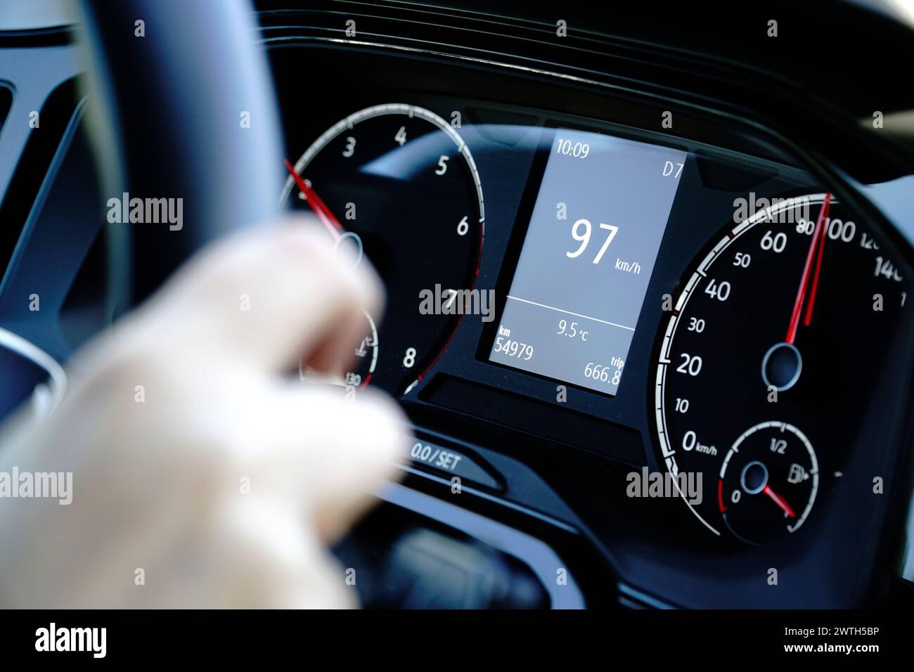 Speedometer and hands on a steering wheel - driving at 97 kmh Stock ...
